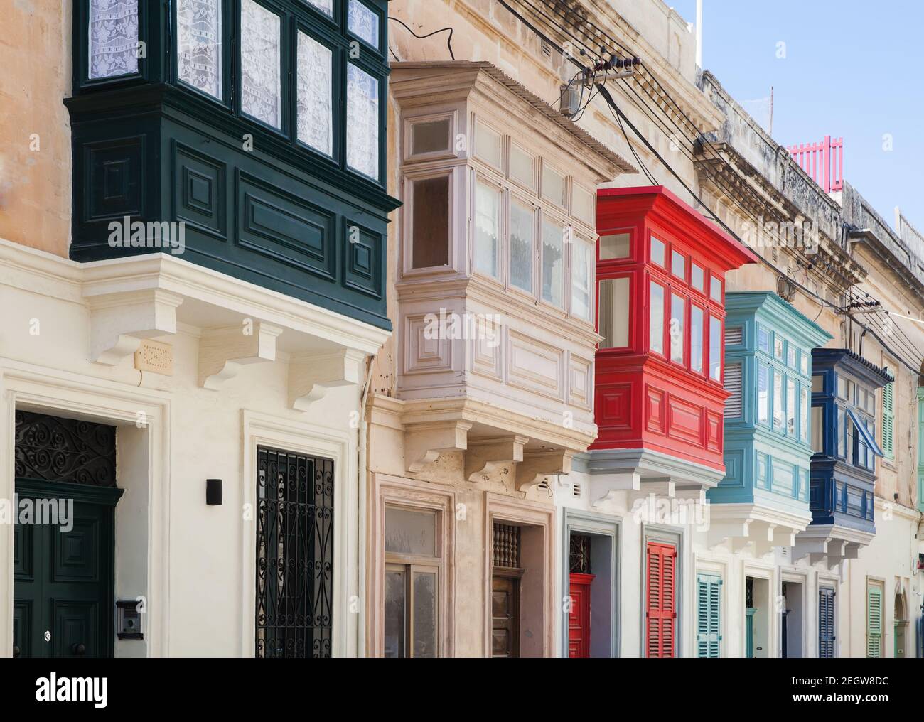 Street view with colorful old balconies. Living houses facades, Rabat ...
