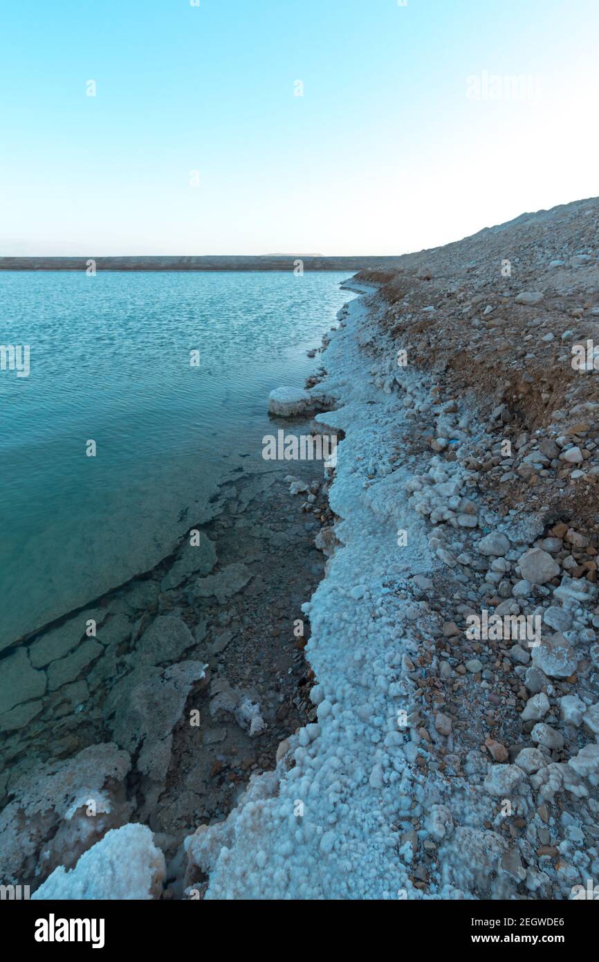 Lumps of salt on the shoreline of the Dead Sea, sunset Stock Photo - Alamy