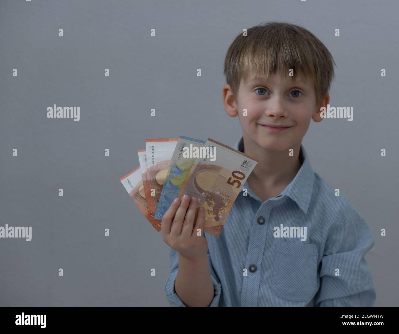 Boy money smiling hi-res stock photography and images - Alamy