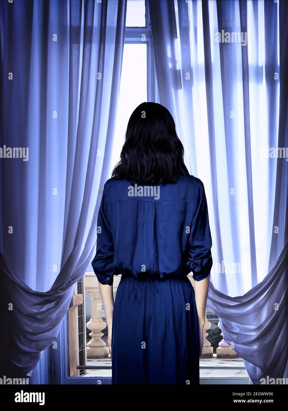 woman looking through window Stock Photo - Alamy