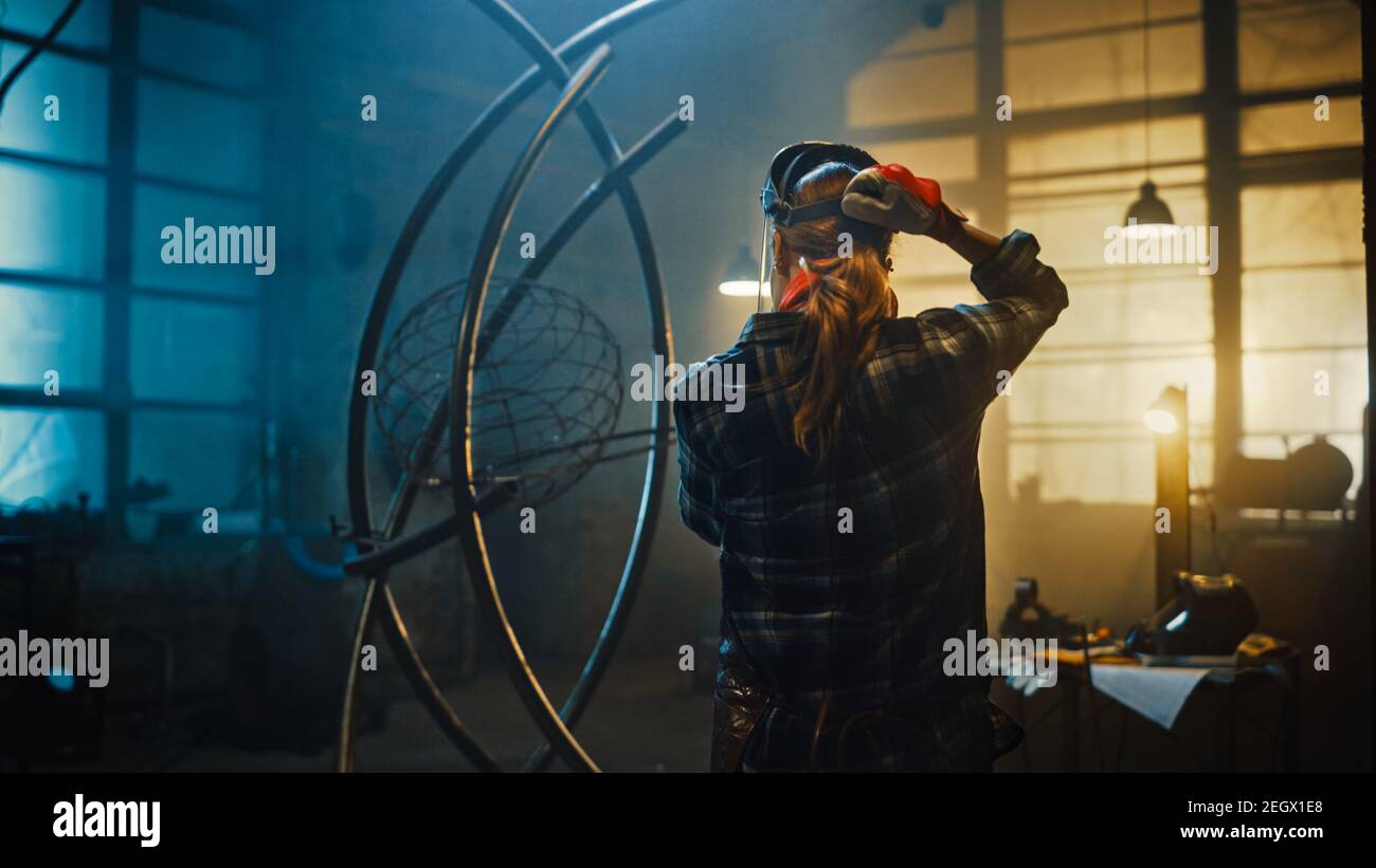 Talented Innovative Female Artist Walks Around Metal Tube Sculpture and ...