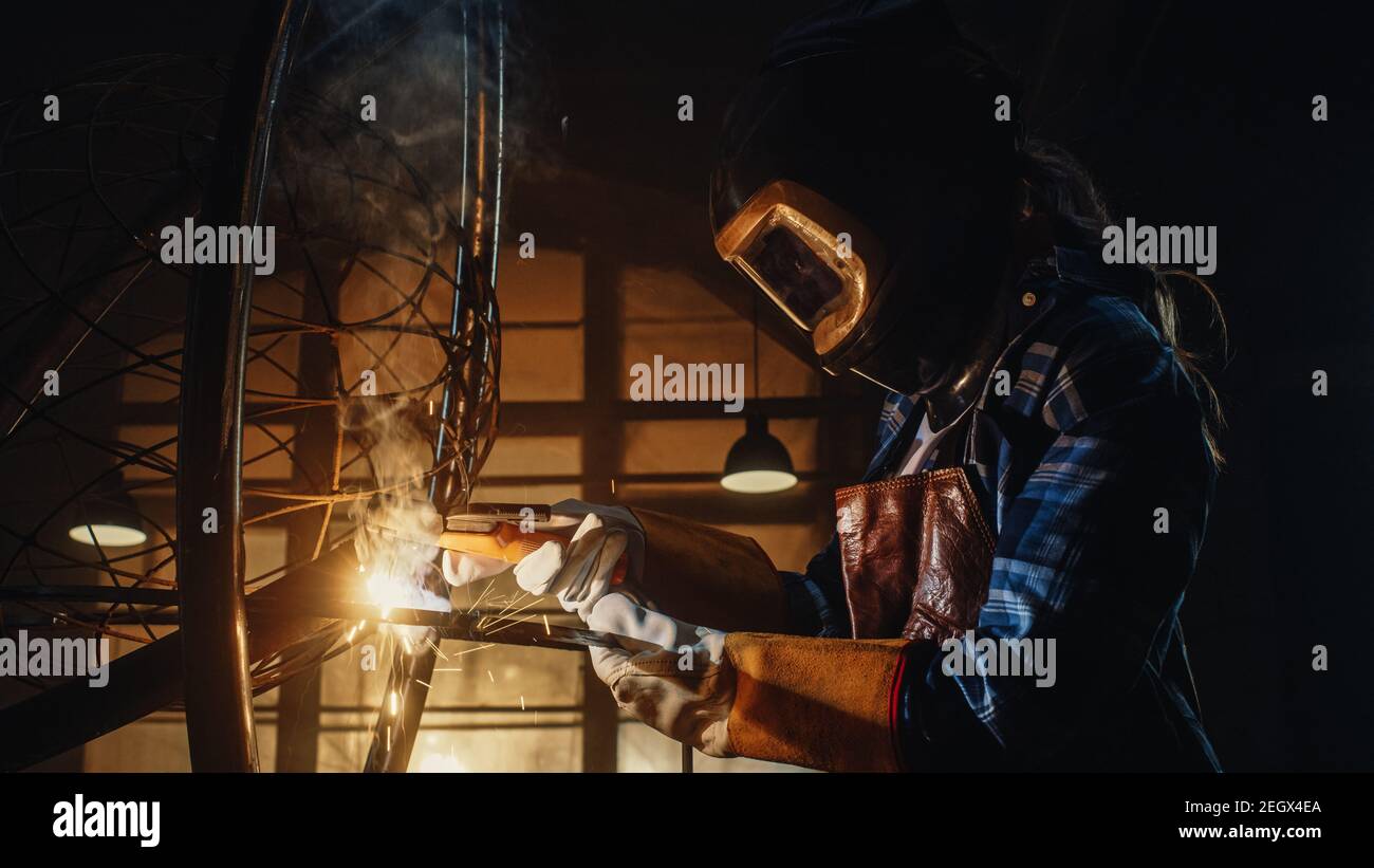 Beautiful Female Artist is Welding a Brutal Metal Sculpture in a Dark ...
