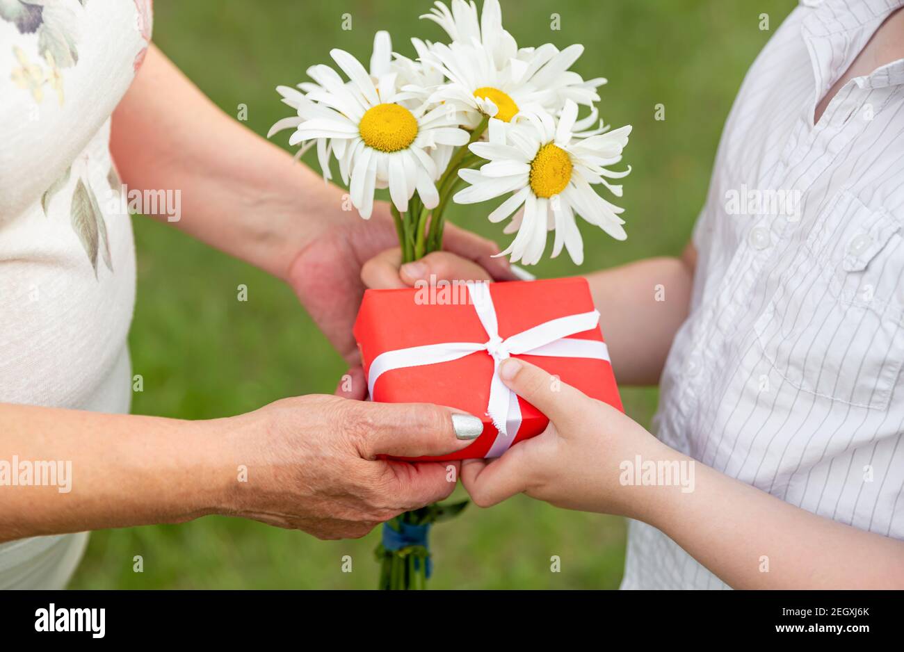 Boy holding gift in hands outdoors hi-res stock photography and images ...