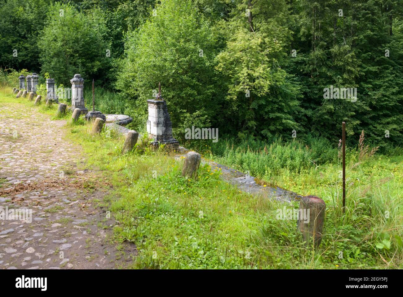 The remains of the railing of the Big white stone bridge in the park of ...