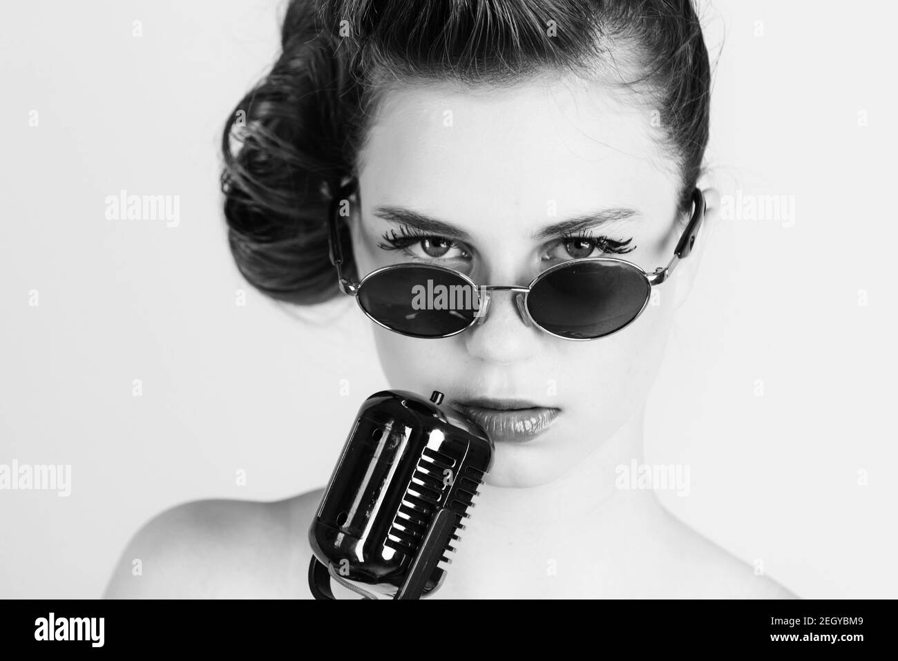 Karaoke party. Time to sing. Retro casual curly chic girl singing with ...