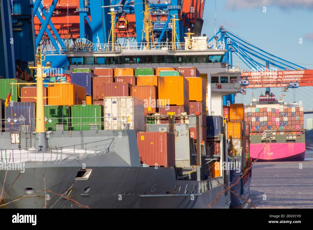 Two container vessels quayside in Harbour during loading at the pier on ...