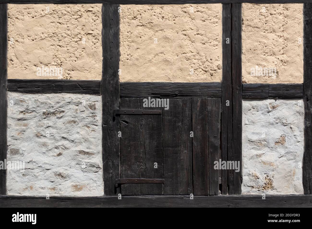 Old half-timbered detail of a barn with a small wooden door Stock Photo ...