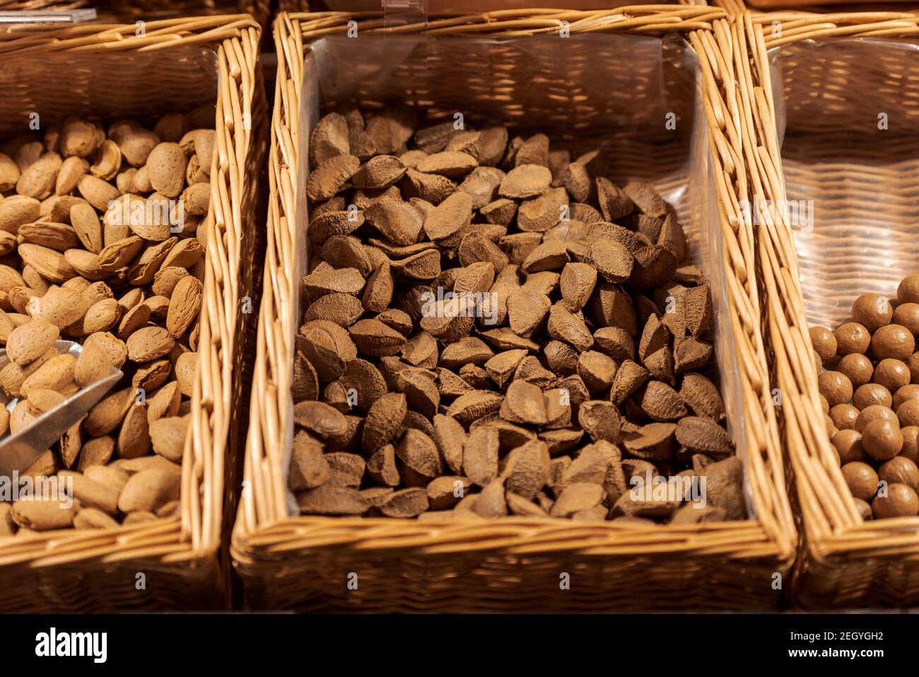 Unpacked Brazil nuts in nutshell in basket on display in organic super ...