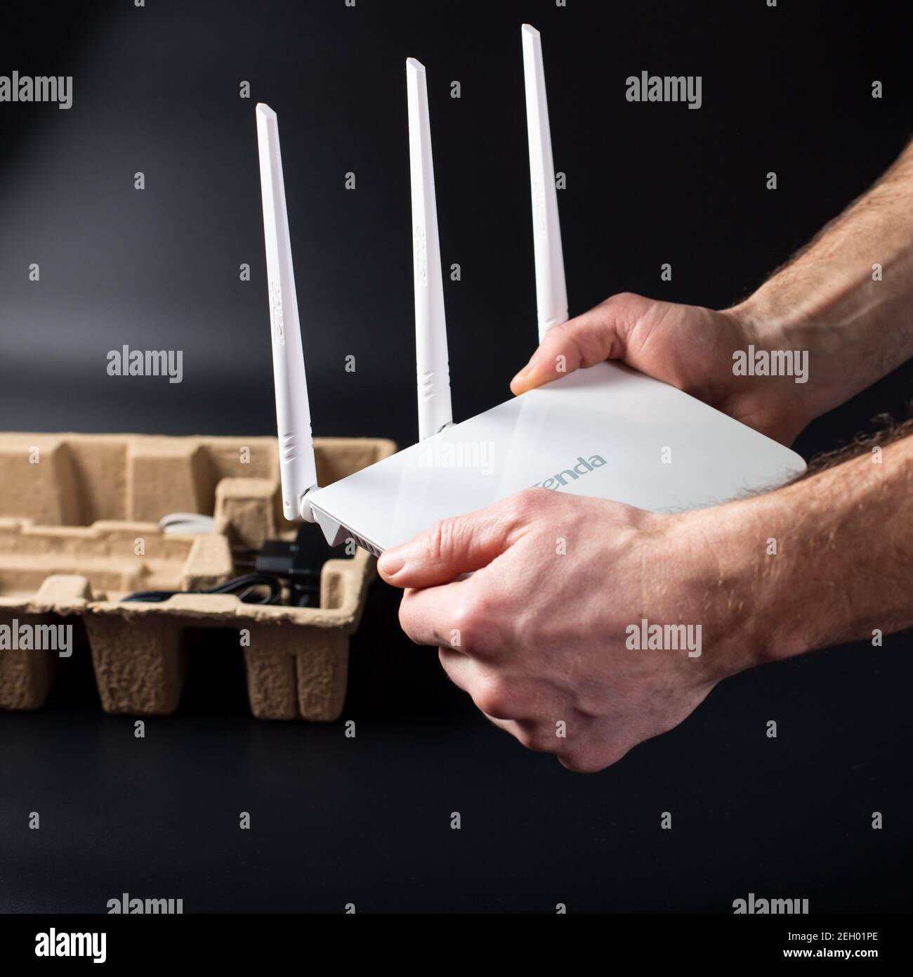 Male hands unpacking brand new WiFi router on black background Stock ...