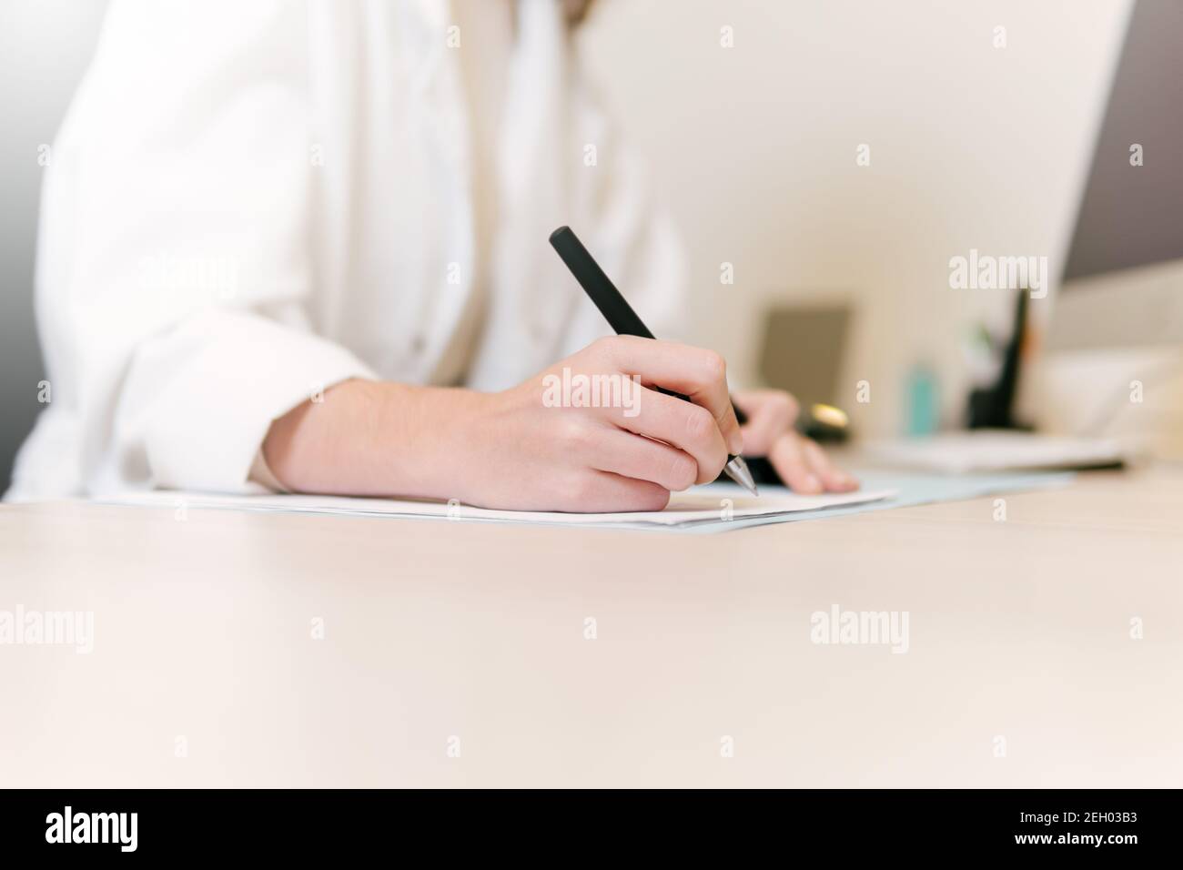 Doctor writing prescription desk close hi-res stock photography and ...