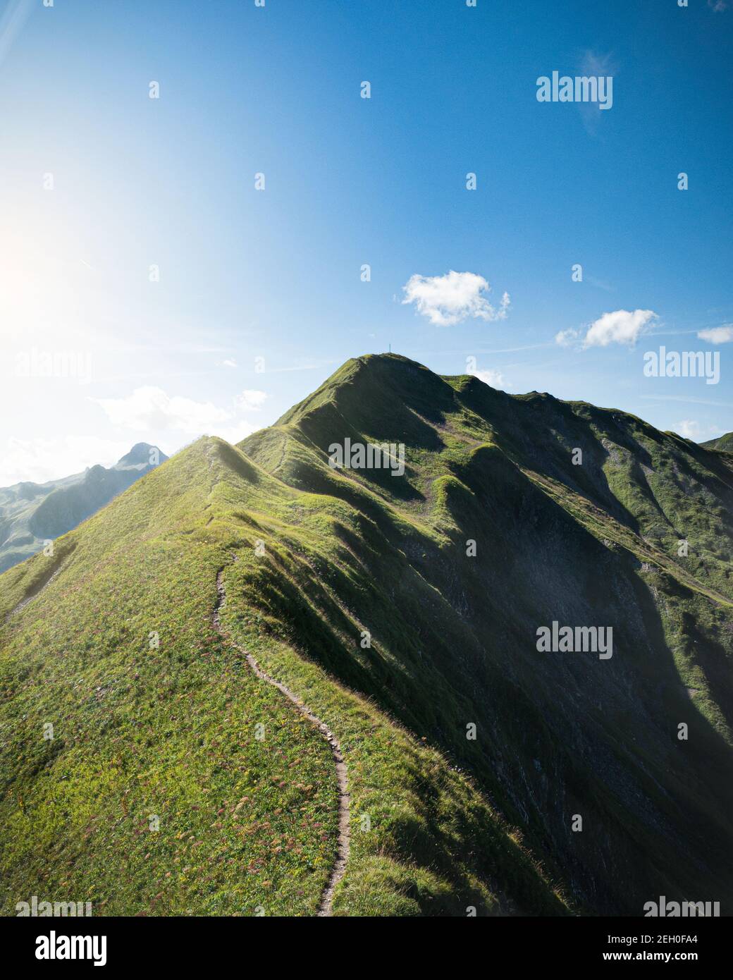 A path alongside a mountain ridge in Vorarlberg, Austria Stock Photo ...