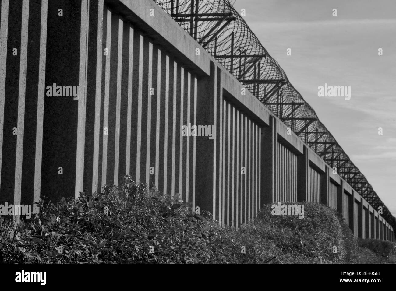Border wall of an atomic plant with barbed wire Stock Photo - Alamy