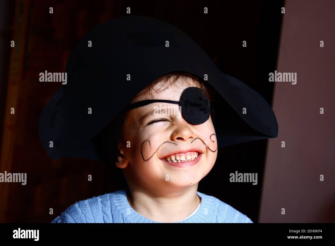 A happy young boy wearing a pirate costume. black background Stock ...