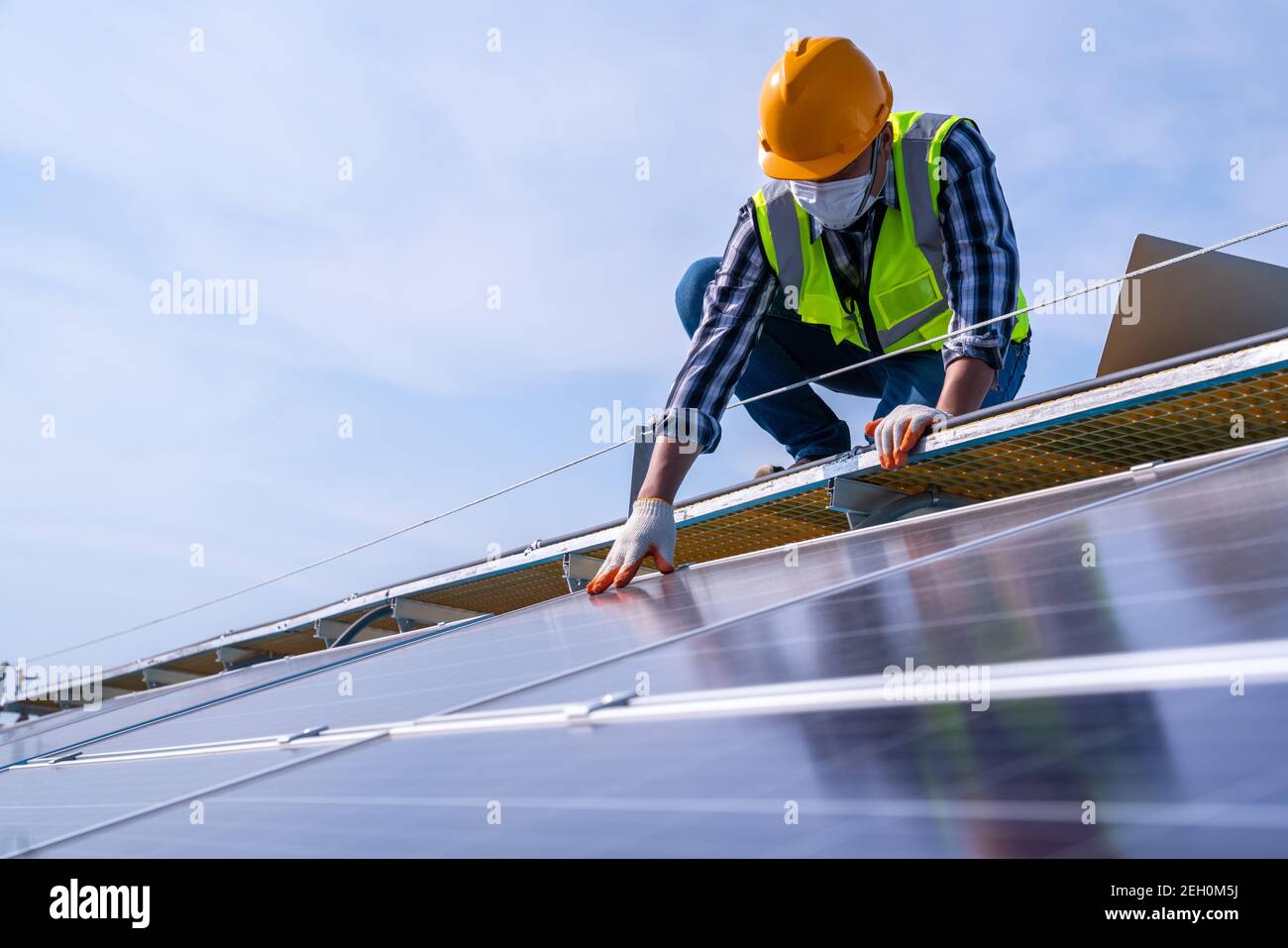 technician checks the maintenance of the solar panels on the roof Stock ...