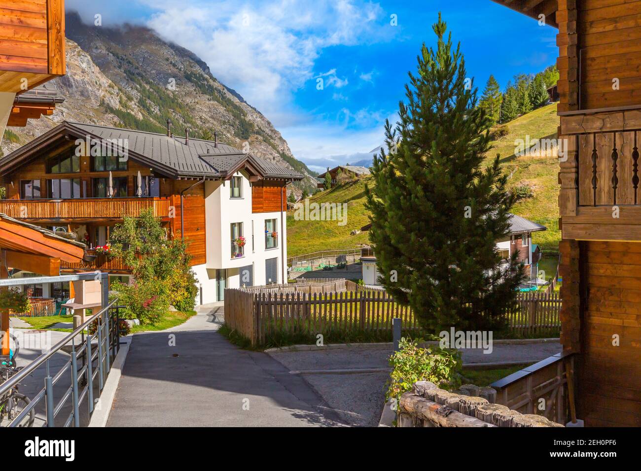 Traditional wooden houses in Zermatt, alpine village summer street view ...