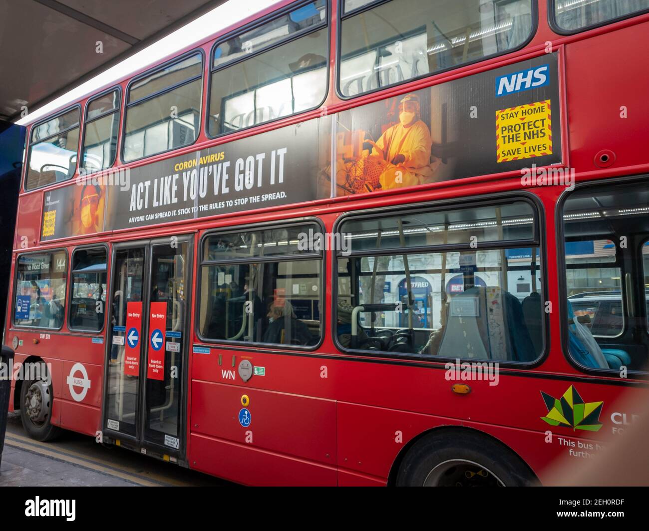 A London double decker bus with a NHS Covid-19 safety advertisement on ...
