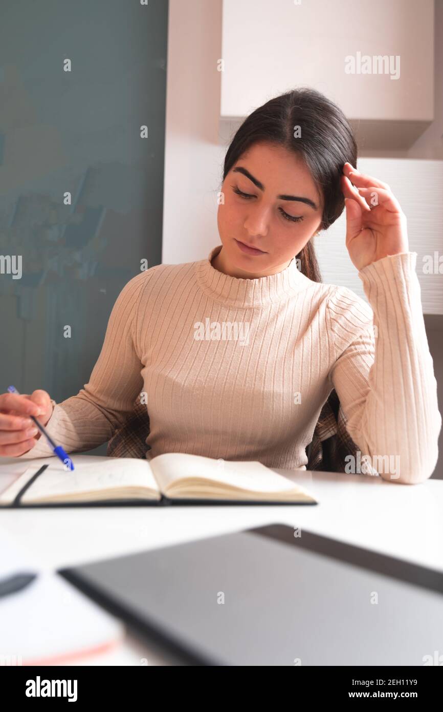 Young woman studying at home Stock Photo - Alamy