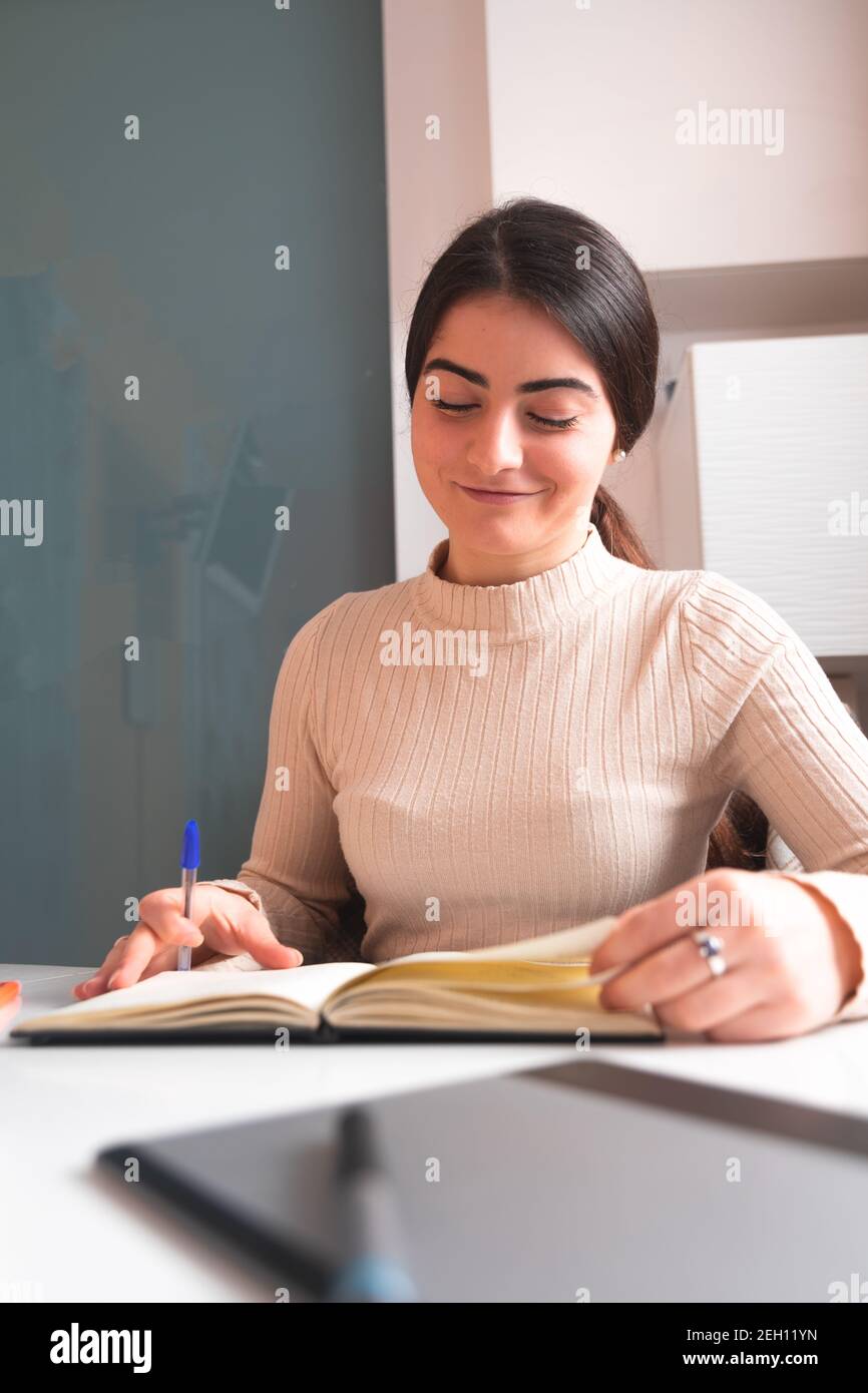 Young woman studying at home Stock Photo - Alamy