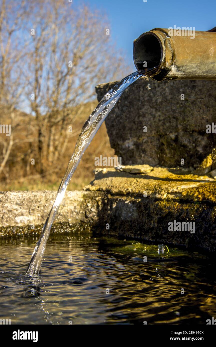 Old fountain pipe with flowing clean drinking water in Puy de Dome ...