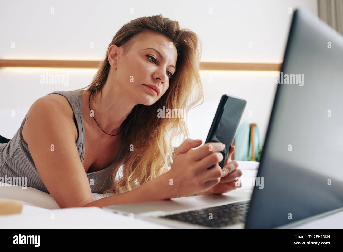 Serious woman texting Stock Photo - Alamy