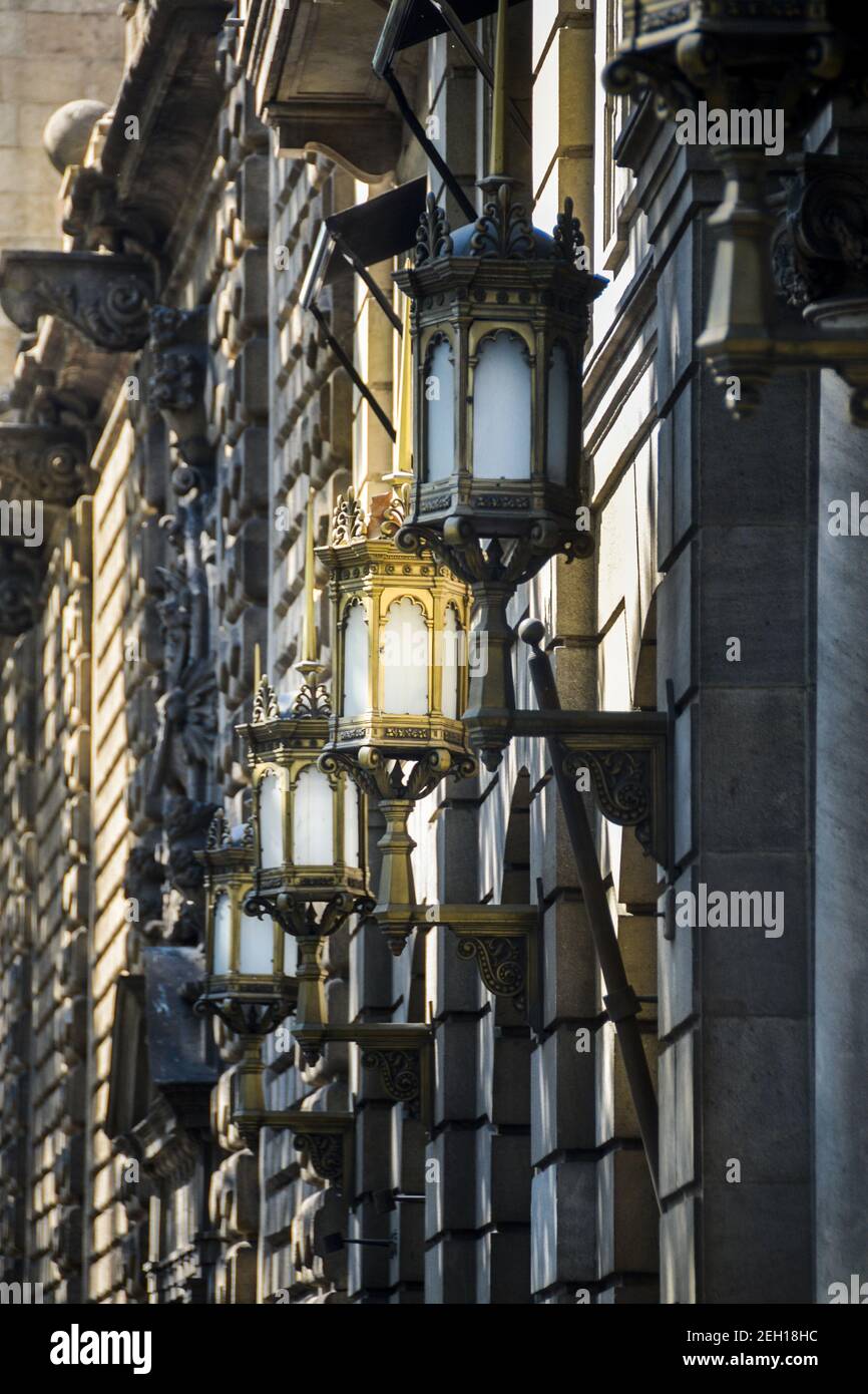Closeup of vintage street lanterns mounted on the wall of an old-style ...