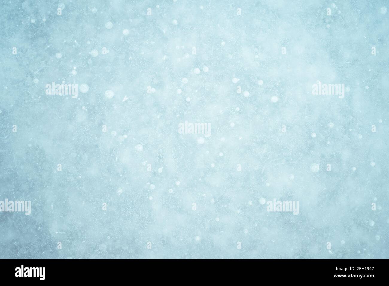 Frozen icy white background with a bluish tint in a natural haze with ...