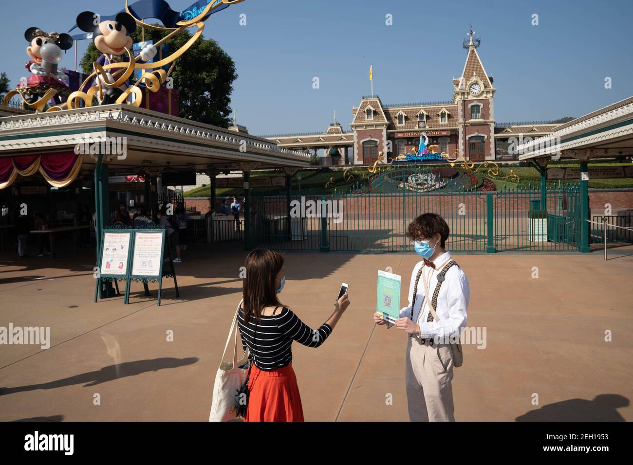 A female visitor uses her mobile phone to scan a health QR code for ...