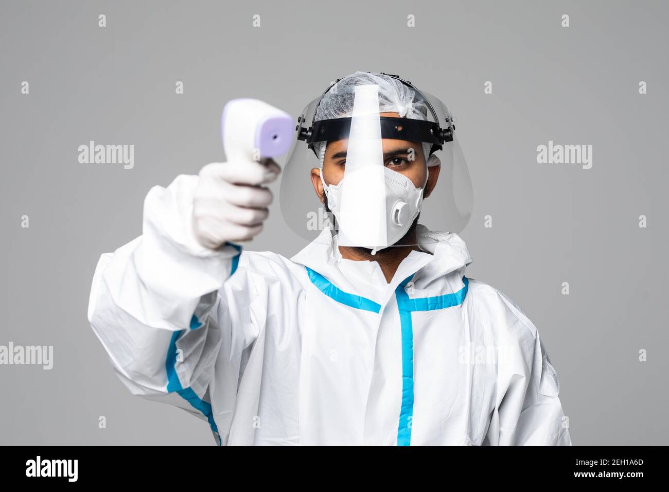 man wearing biological protective uniform suit clothing, mask, gloves ...