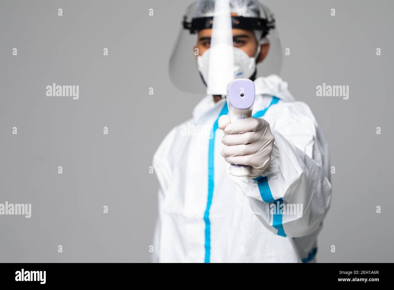 man wearing biological protective uniform suit clothing, mask, gloves ...