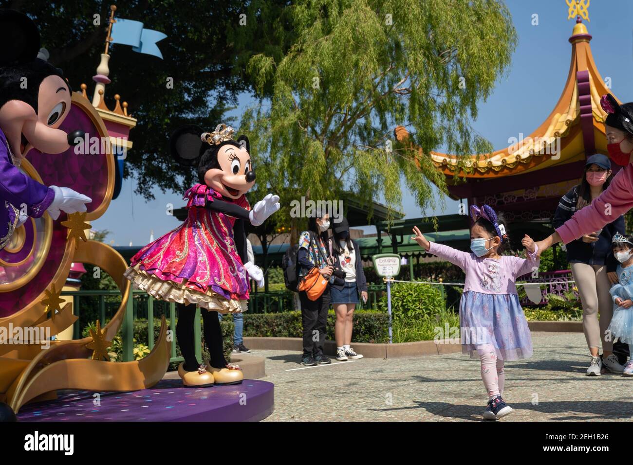 A child interacts with the actors dressed as the Disney cartoon ...