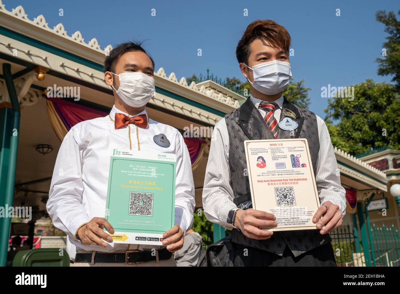 Employees of the Hong Kong Disneyland resort seen holding the health QR ...