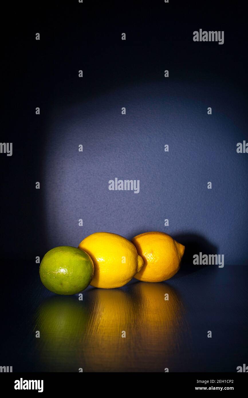 Lemons and lime on blue backdrop Stock Photo - Alamy