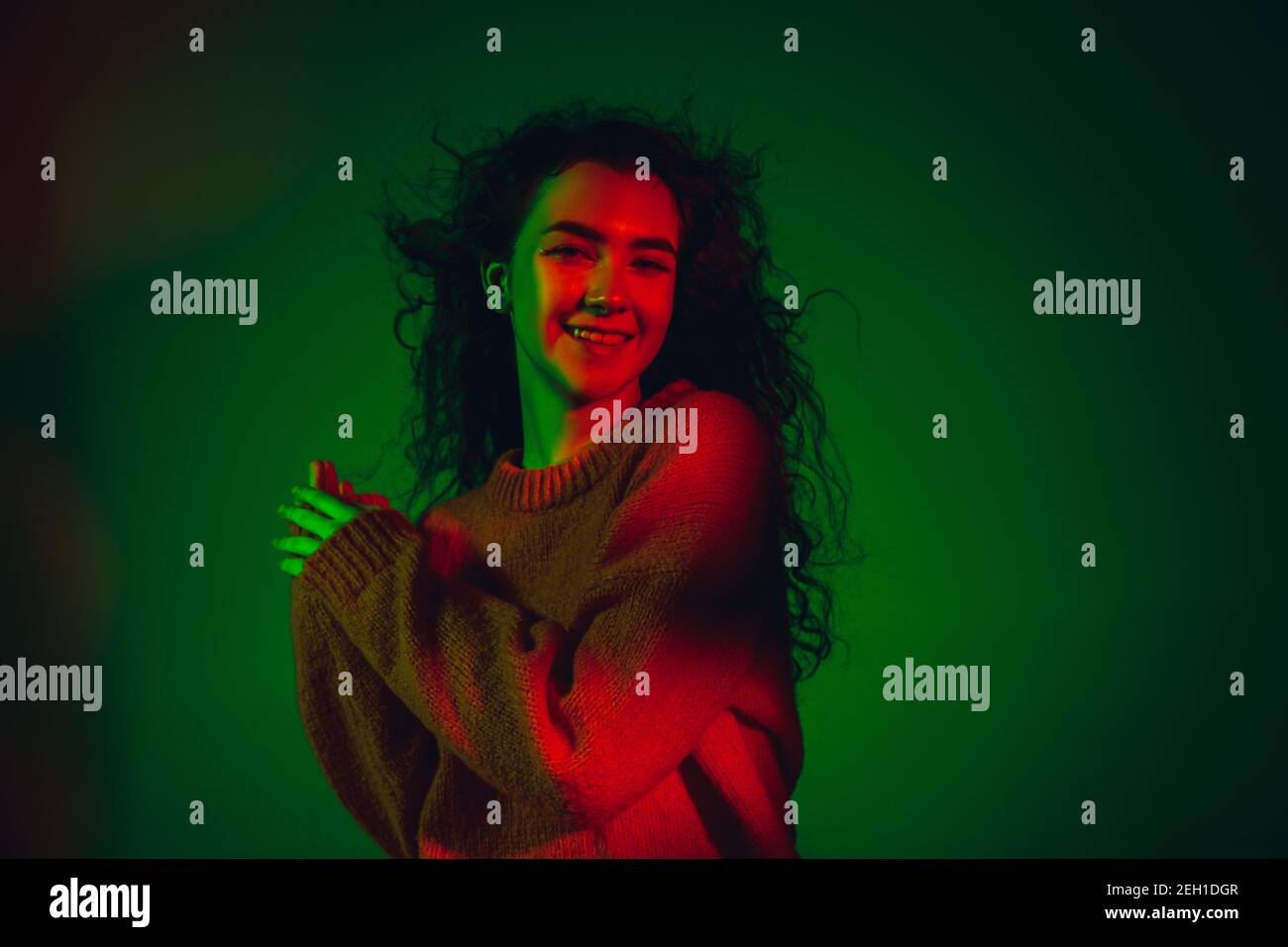 Contented. Caucasian woman's portrait isolated on green studio ...