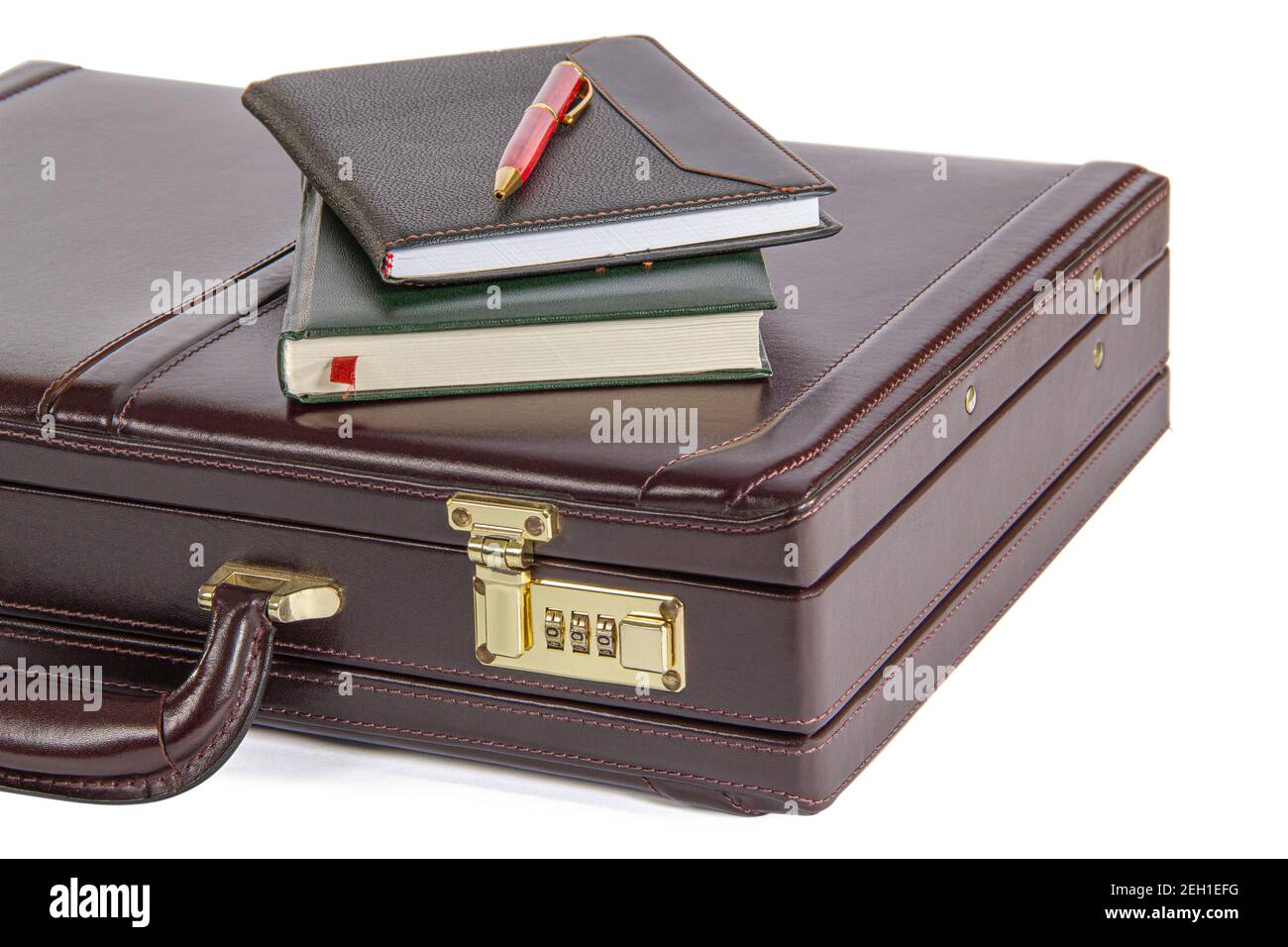 Modern leather suitcase with notebooks and pen, isolated on white ...