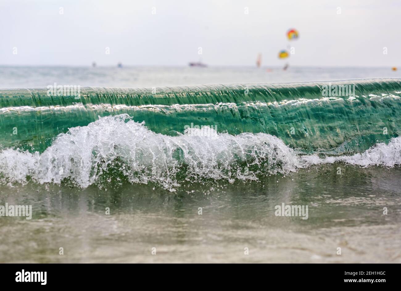 Wave with splashes. Sea wave rolls ashore. Shallow depth of field Stock ...