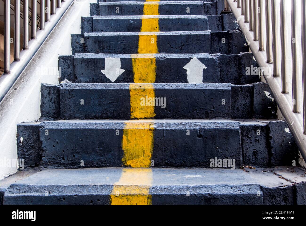 Yellow line and direction arrow painted on Concrete Stair of Overpass ...