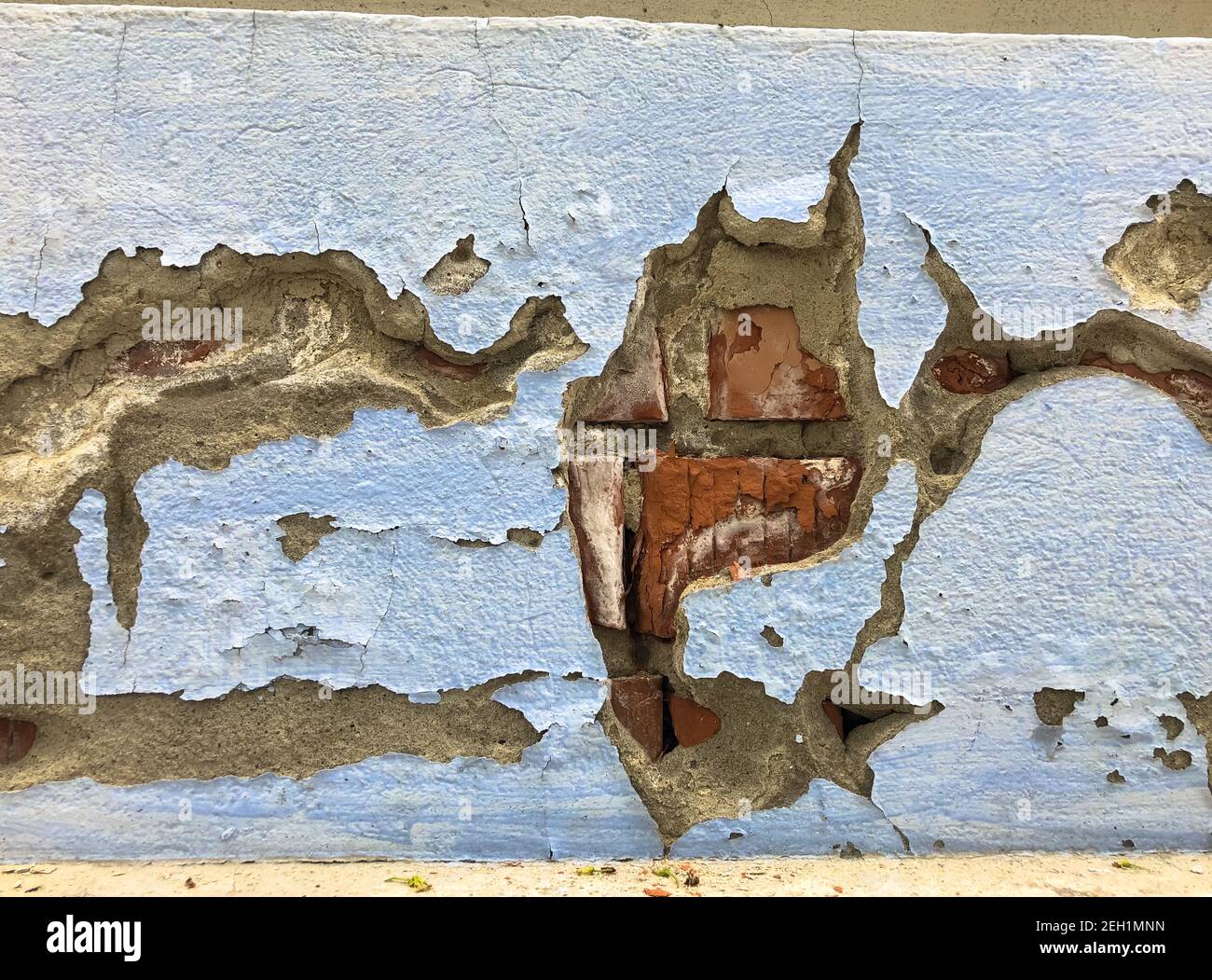 The surface of an old dilapidated wall with deep cracks. Red bricks ...