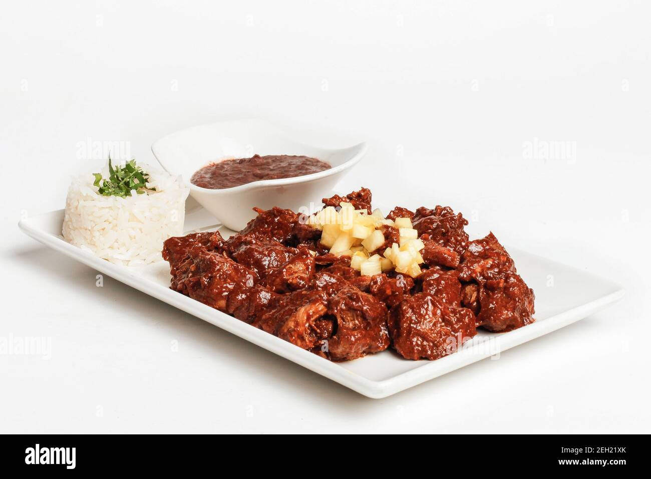 Closeup shot of deliciously prepared meat in sauce served with rice ...