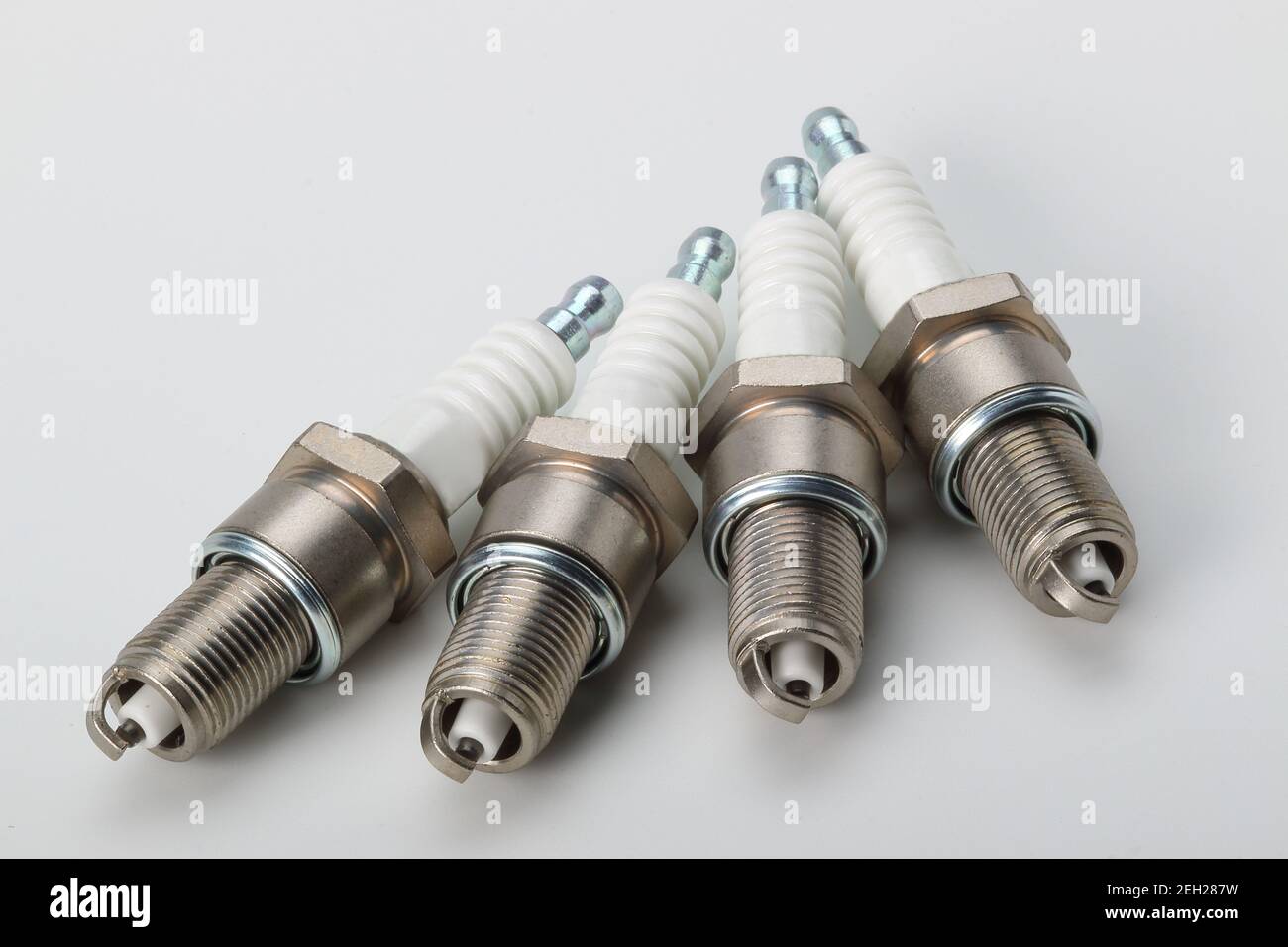 Spark plug set with a white background Stock Photo - Alamy