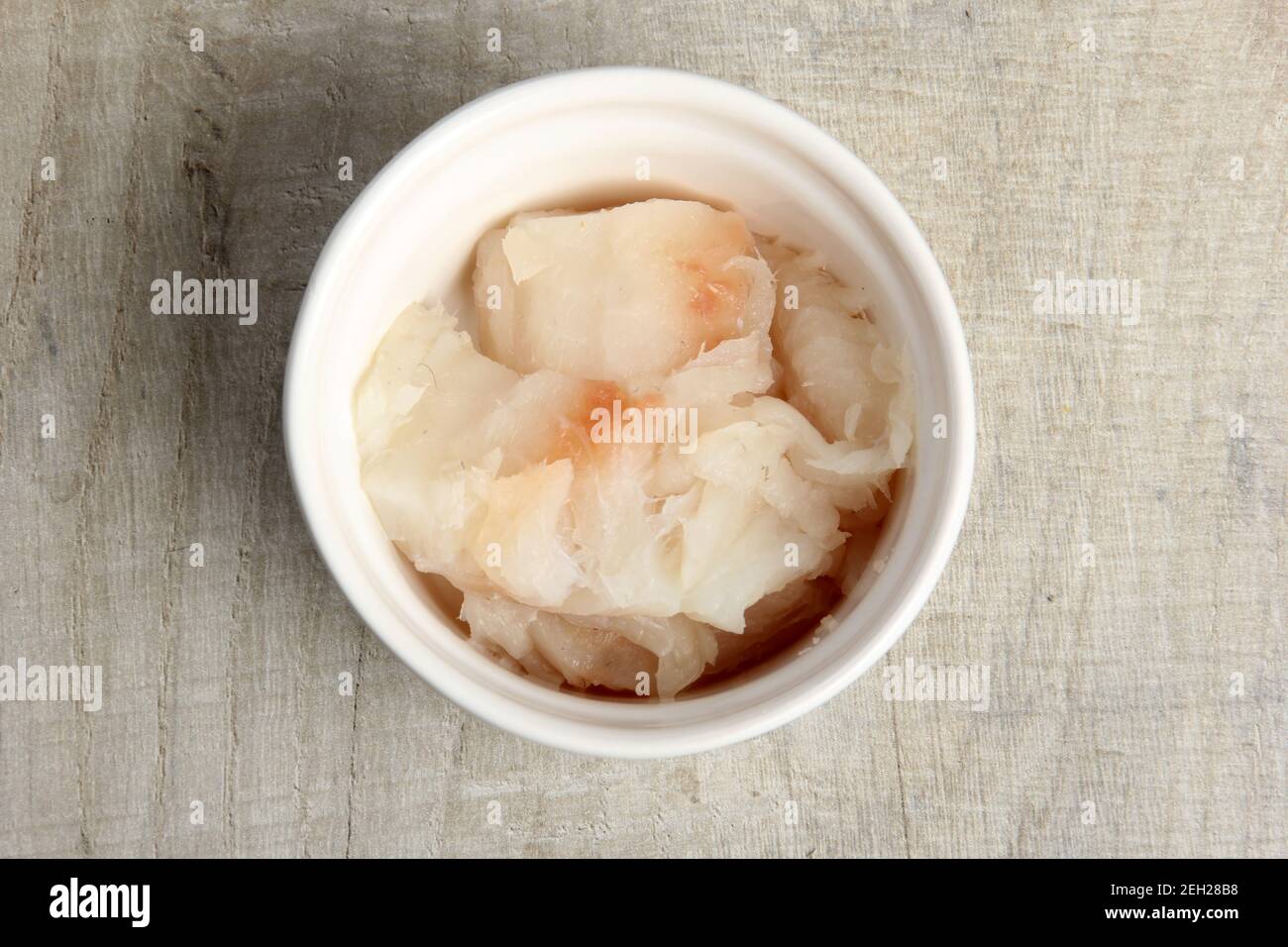 several dishes with raw fresh fish pieces before frying. dishes with ...