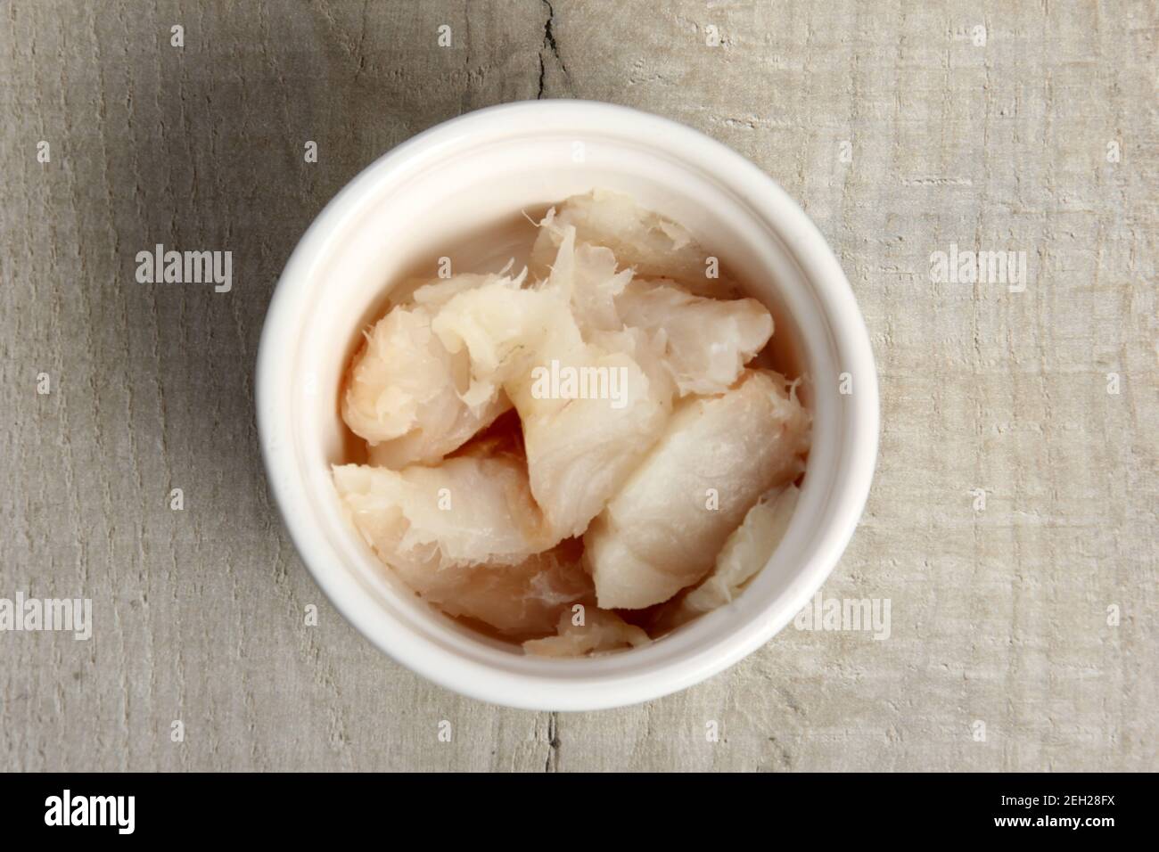 several dishes with raw fresh fish pieces before frying. dishes with ...