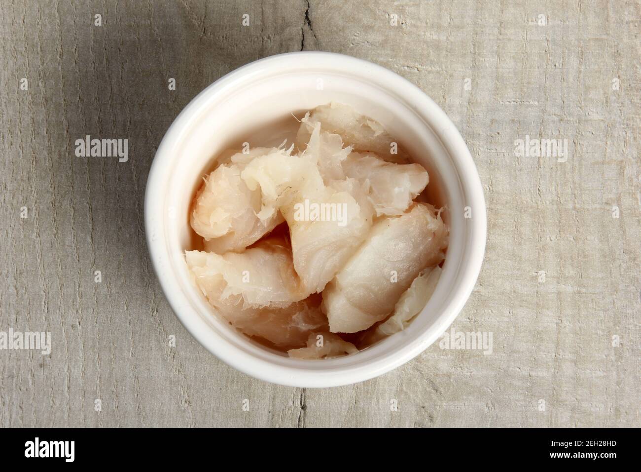 several dishes with raw fresh fish pieces before frying. dishes with ...