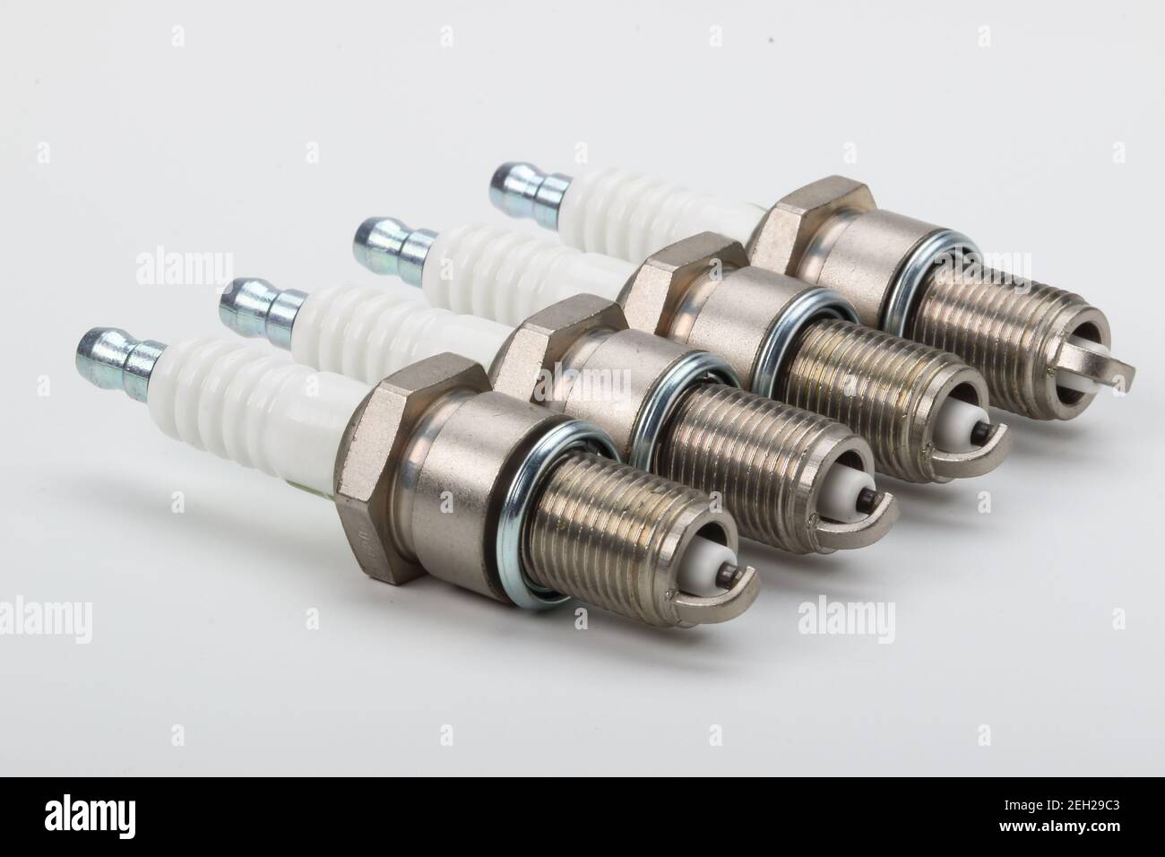 Spark plug set with a white background in line Stock Photo - Alamy