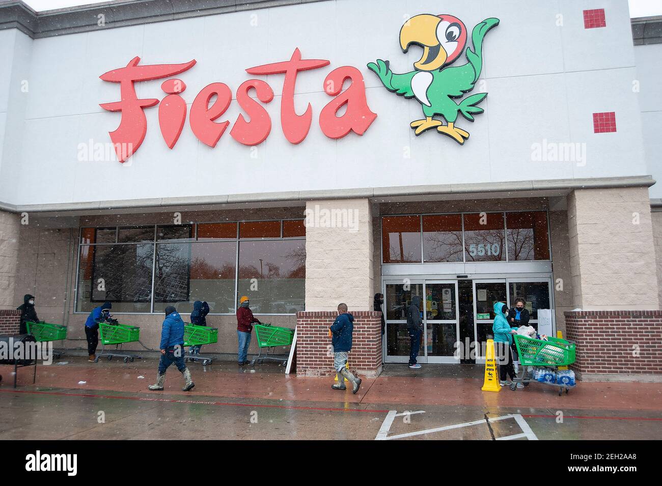 People wait in line to enter Fiesta supermarket in Austin, Texas on ...