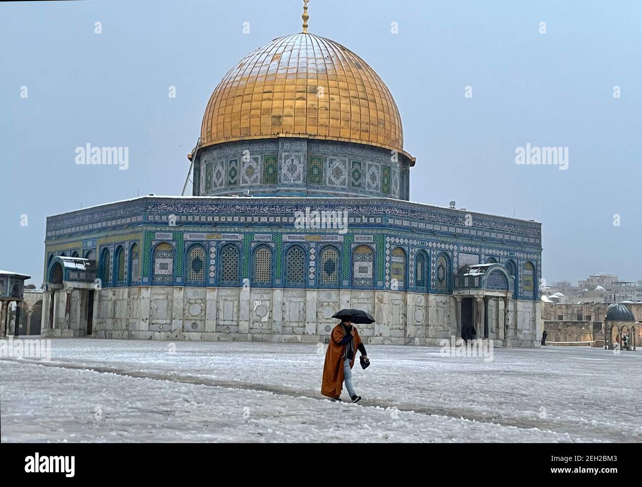 Jerusalem. 18th Feb, 2021. A man walks near the Dome of the Rock after ...