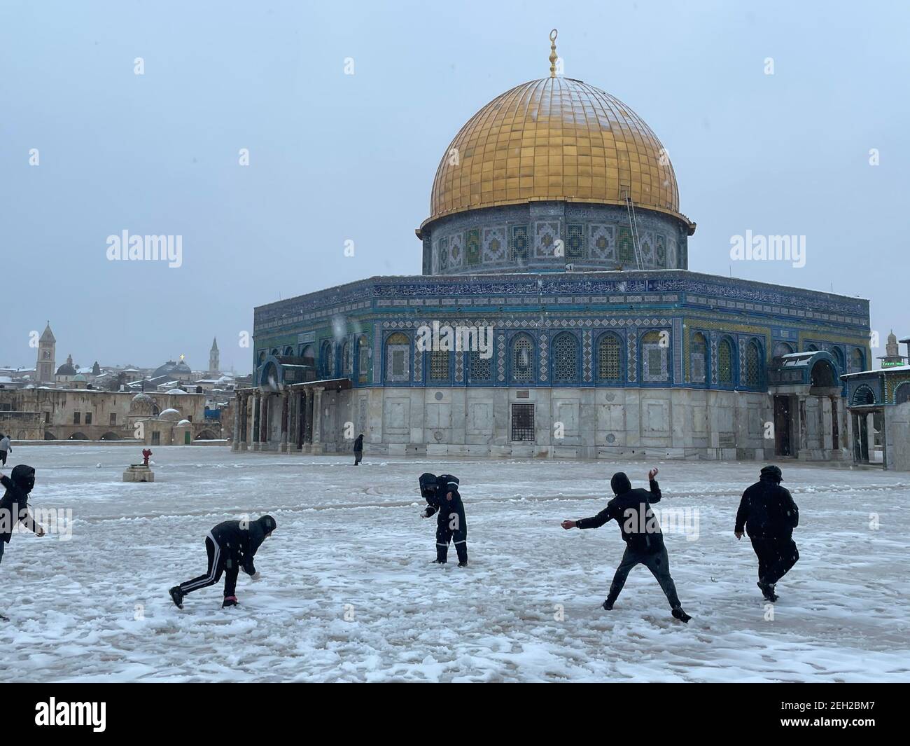Jerusalem. 18th Feb, 2021. People play near the Dome of the Rock after ...
