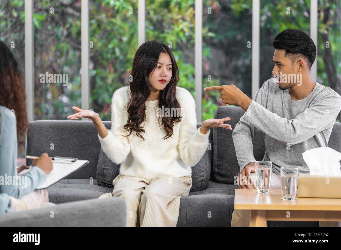 Rear view of coach listening and looking Asian young lovers Arguing ...