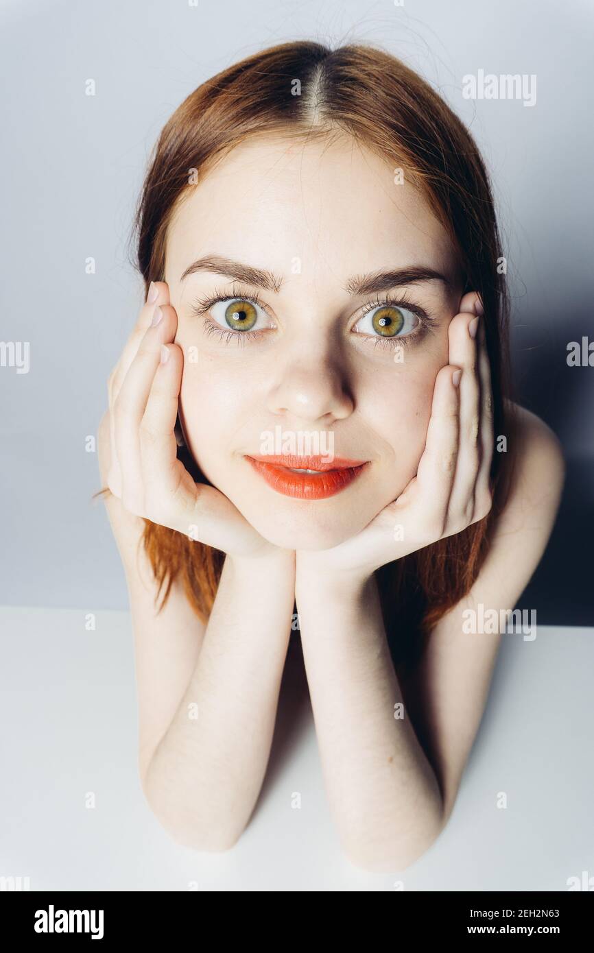 woman with wide open eyes holding hands on face emotions close-up Stock ...
