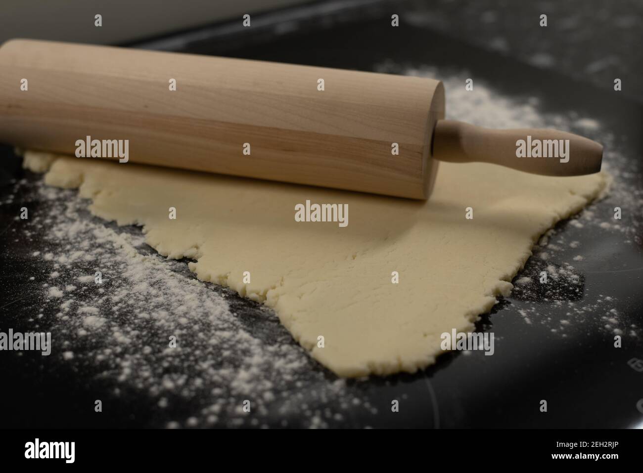 Raw dough flattened with wooden rolling pin Stock Photo - Alamy