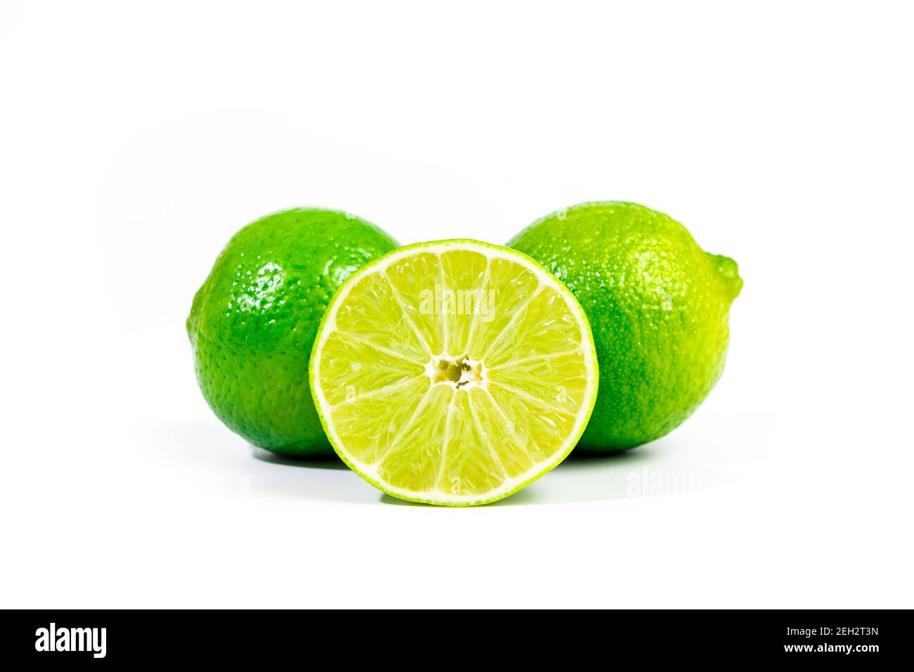 Two whole limes and slice of lime fruit isolated on white background ...